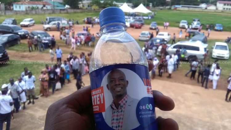 Delegates in queue being refreshed with branded bottle water of the ...